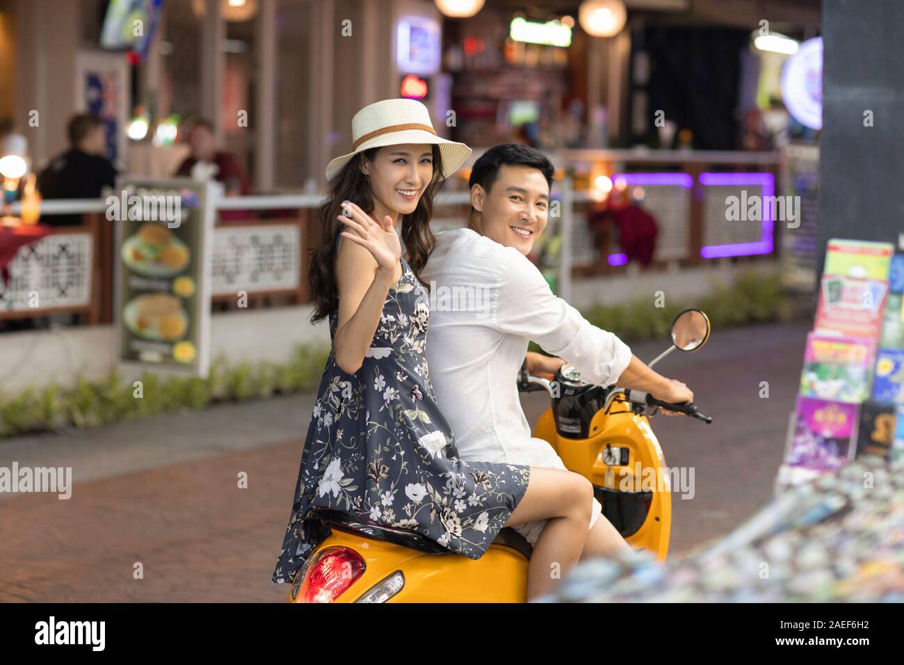 Happy young couple riding motorcycle together Stock Photo - Alamy