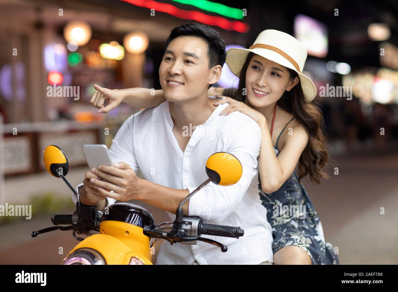 Happy young couple riding motorcycle together Stock Photo - Alamy