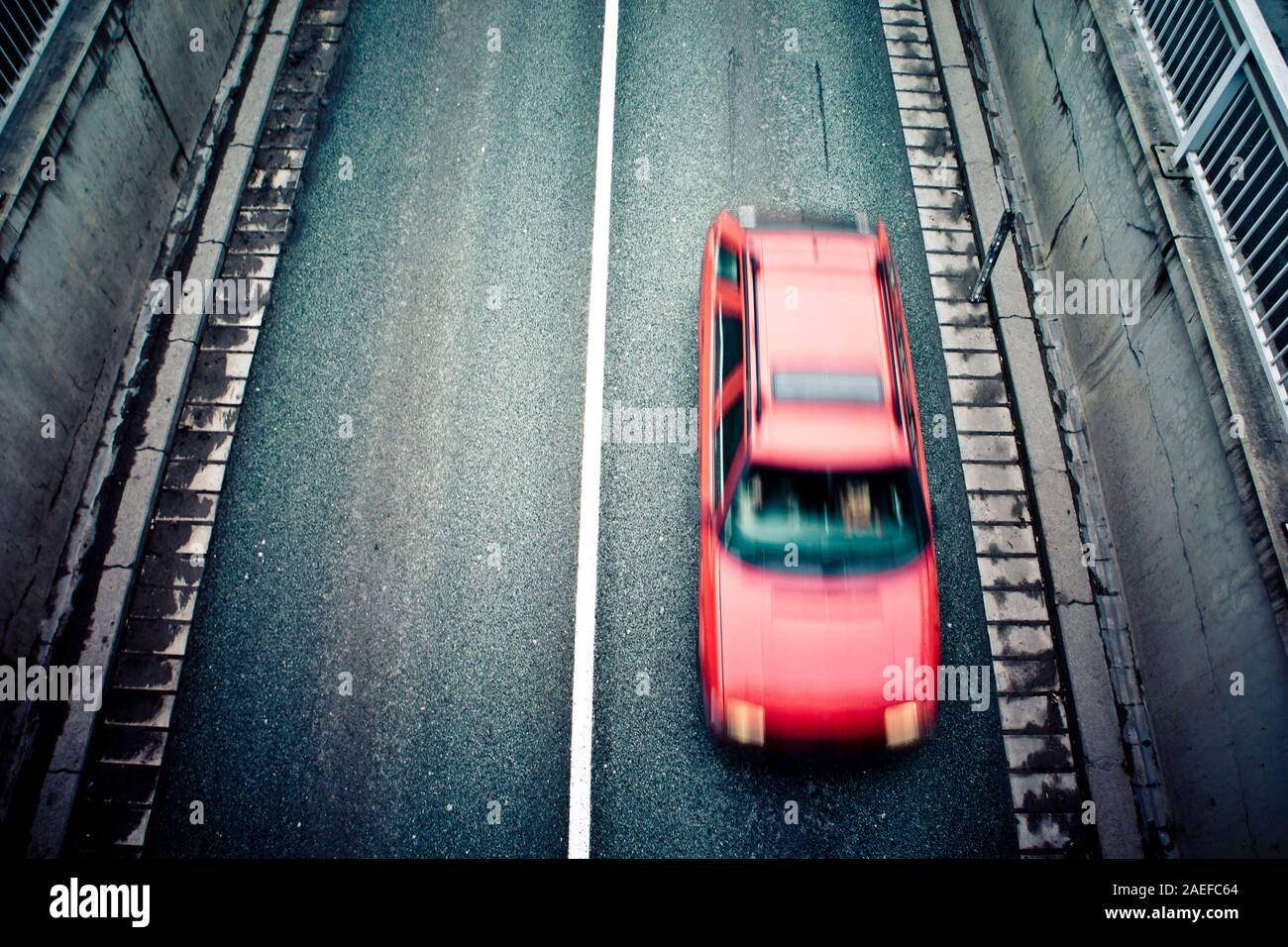 blurred red car driving along a city road, viewed from above Stock ...