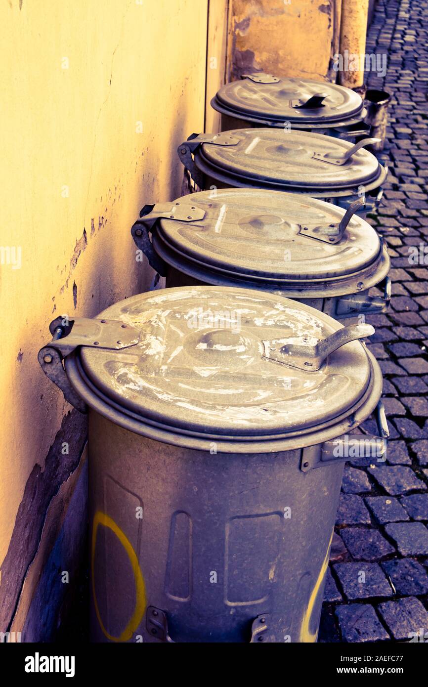 four metal waste container in a row Stock Photo - Alamy