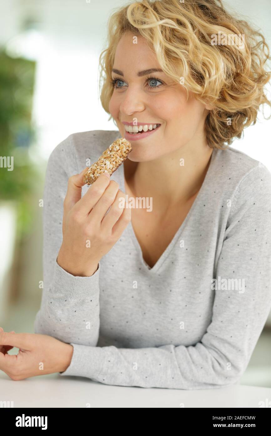 Girl eating granola bar hi-res stock photography and images - Alamy