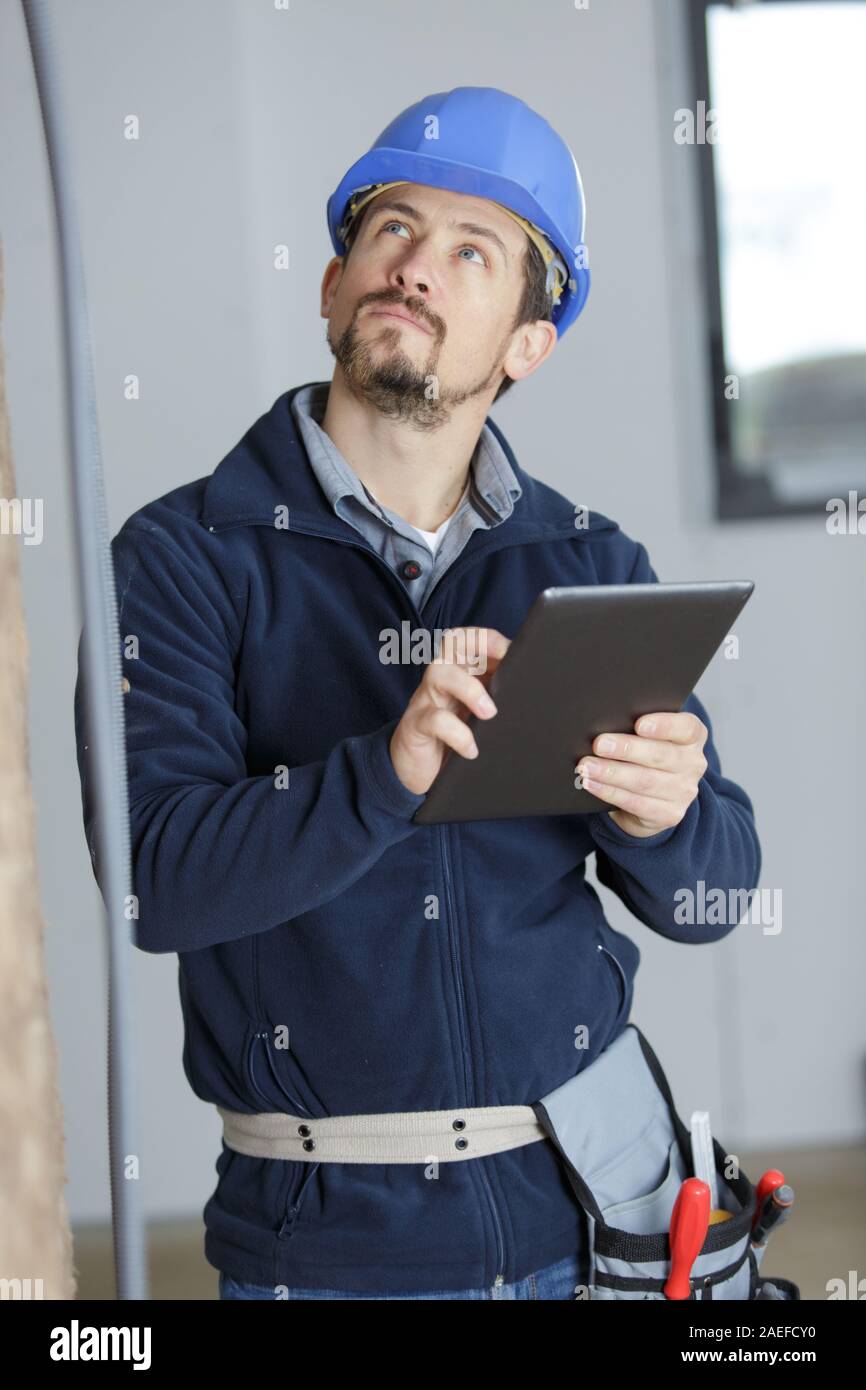 worker using a tablet in a construction site Stock Photo - Alamy