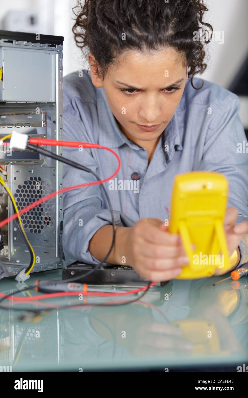 woman checking computer with a multimeter Stock Photo - Alamy