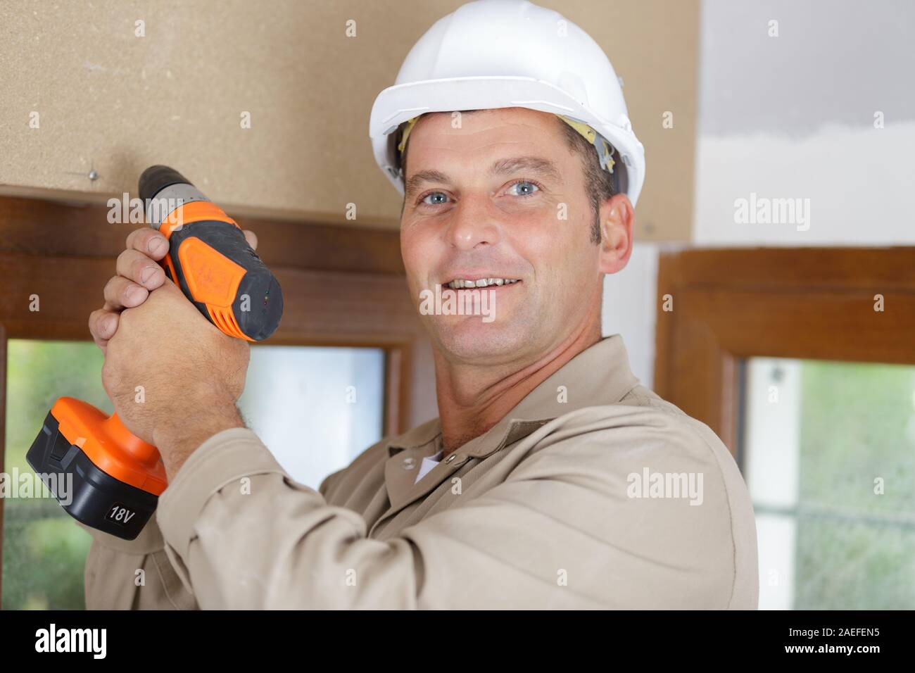 happy man holding a rotary drill Stock Photo - Alamy