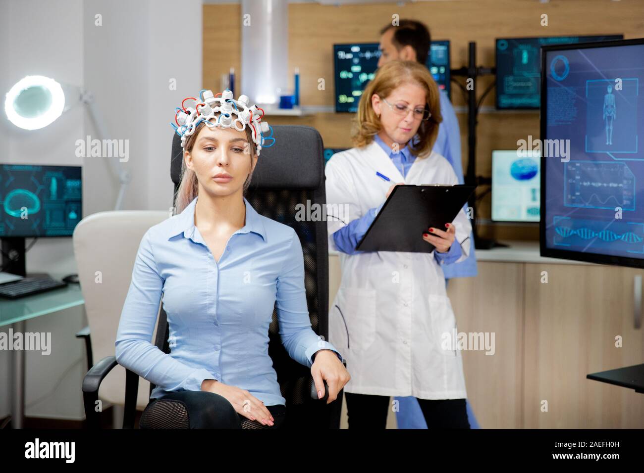 Doctor who notes in the clipboard the evolution of the patient during ...