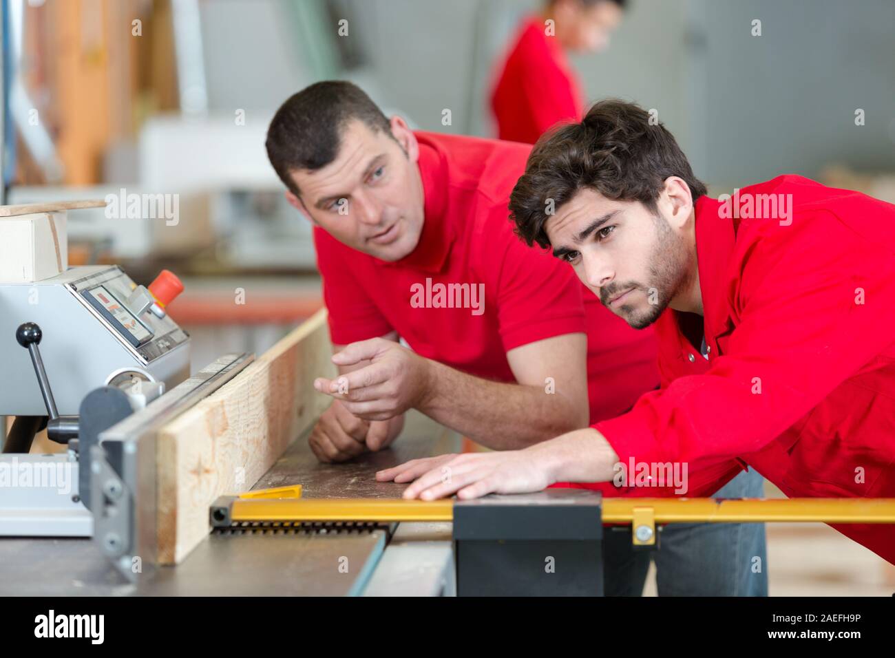 two men using woodworking machine Stock Photo - Alamy