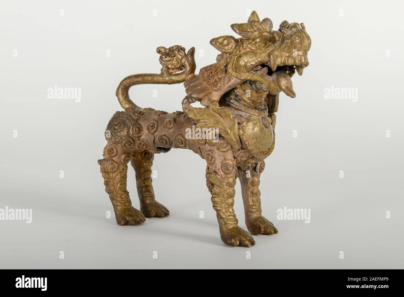 Asian bronze lion statue isolated on white Stock Photo - Alamy