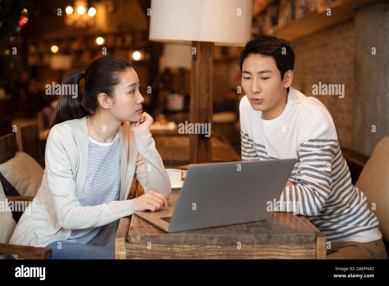 Young university students studying in coffee shop Stock Photo - Alamy