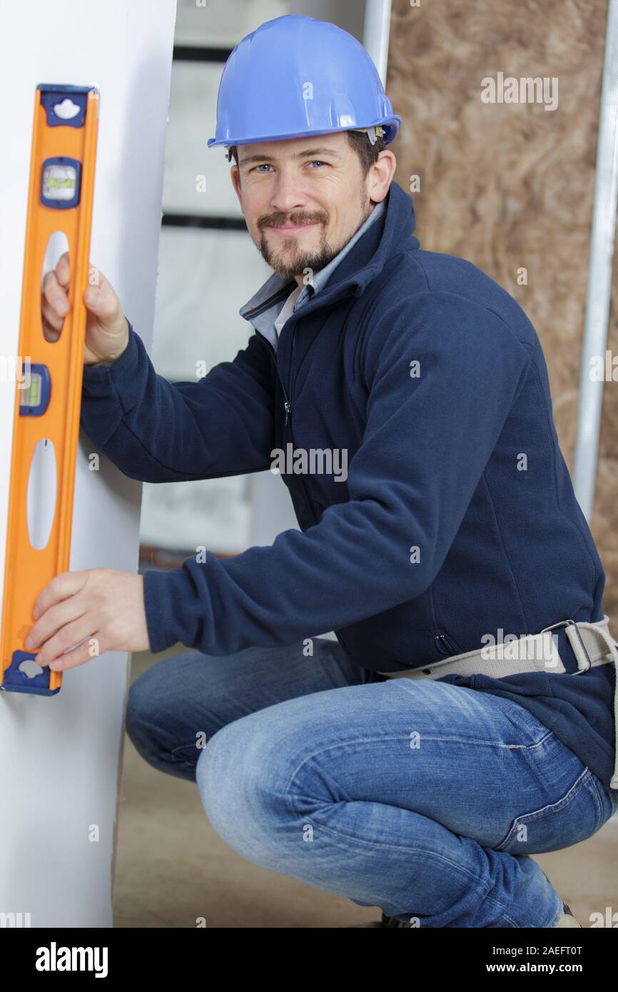 a male builder is with level Stock Photo - Alamy