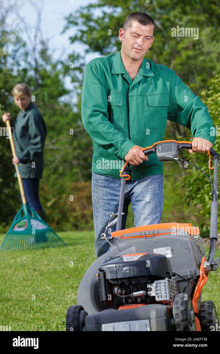 Worker mowing grass using trimmer hi-res stock photography and images ...