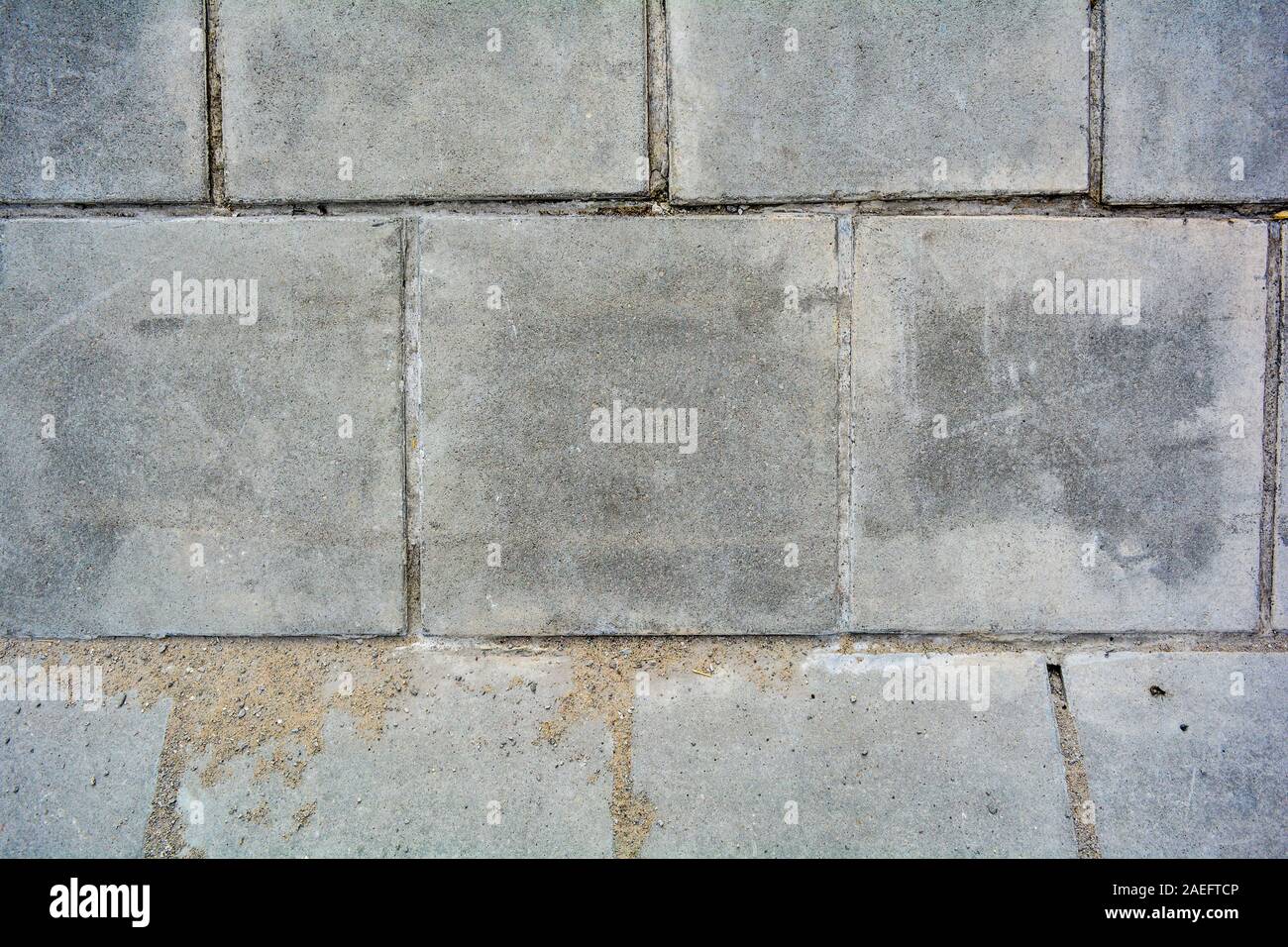 Large square cement street floor slabs. Texture of gray dirty tiles ...