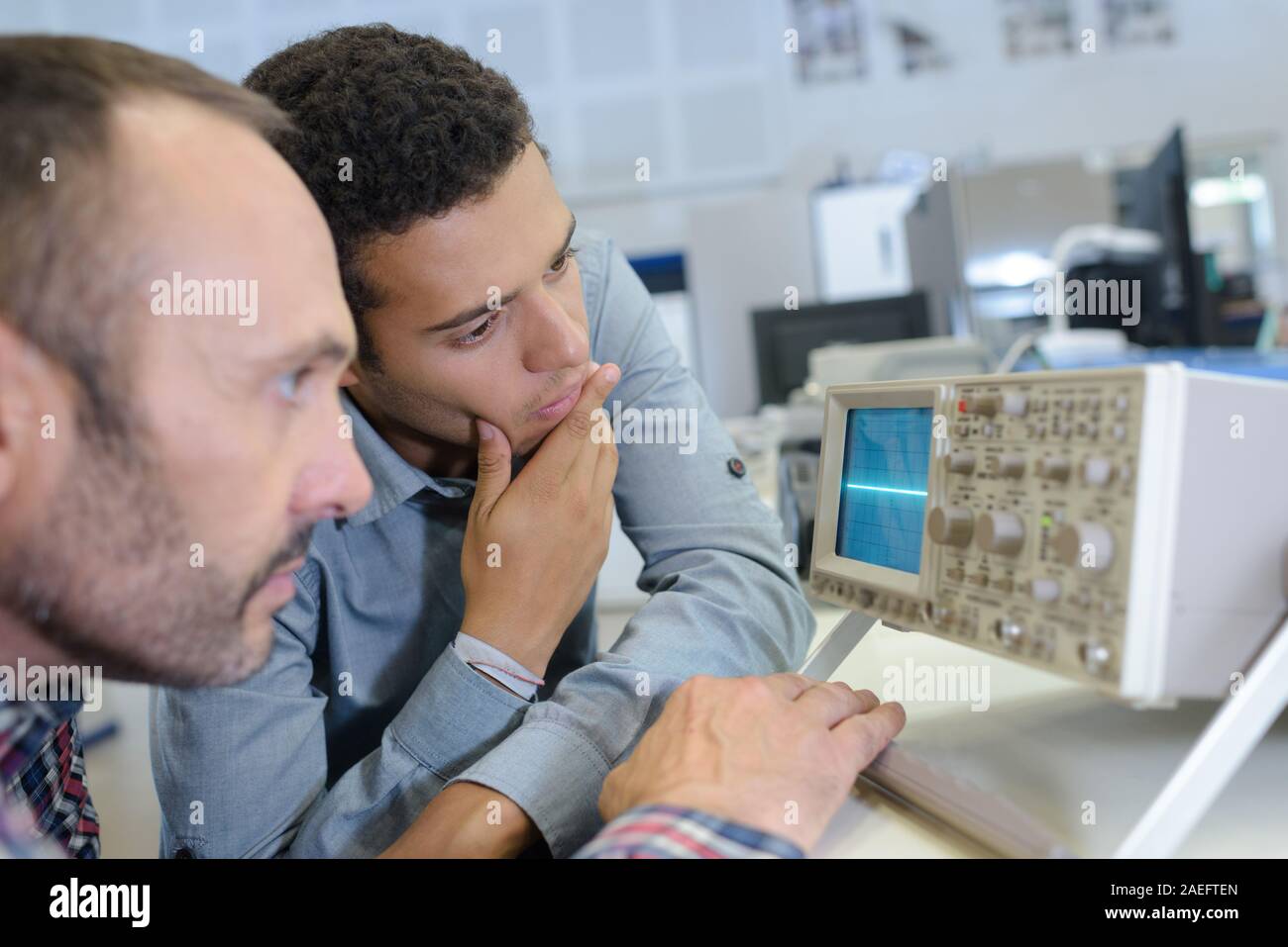 two men looking at radio frequency screen Stock Photo - Alamy