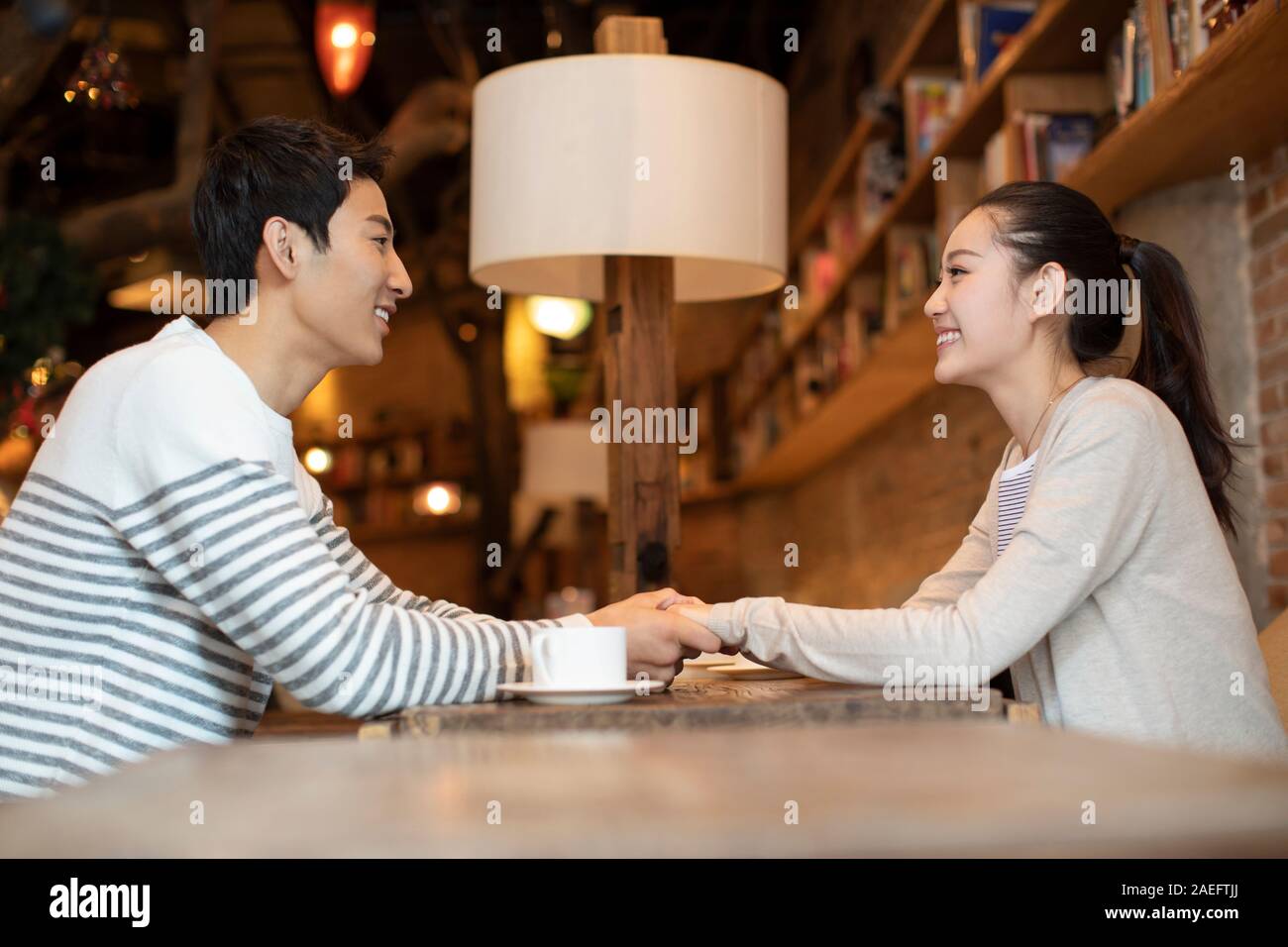 Loving couple in cafe holding hi-res stock photography and images - Alamy