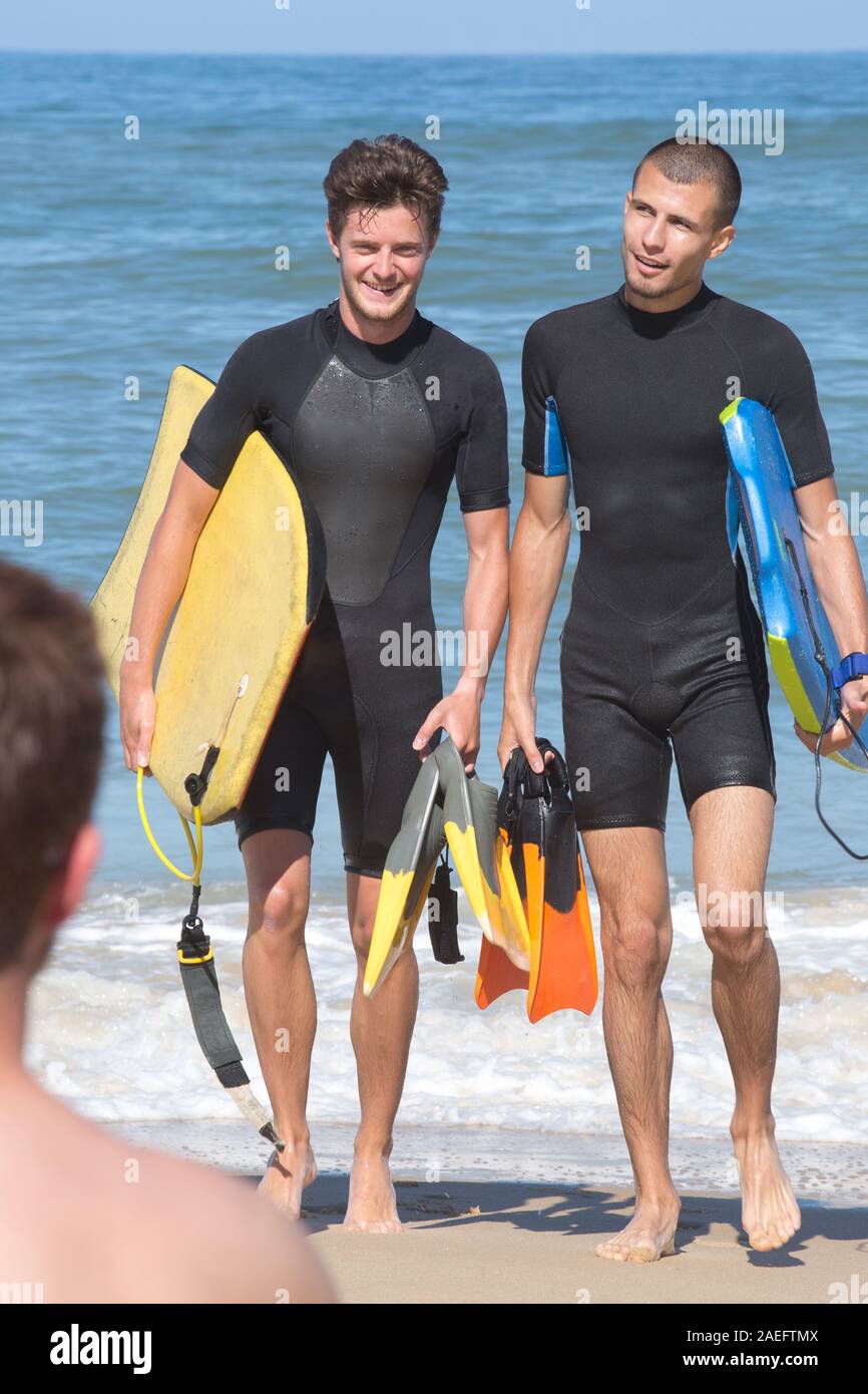 two surfer bodyboard men on the beach Stock Photo - Alamy