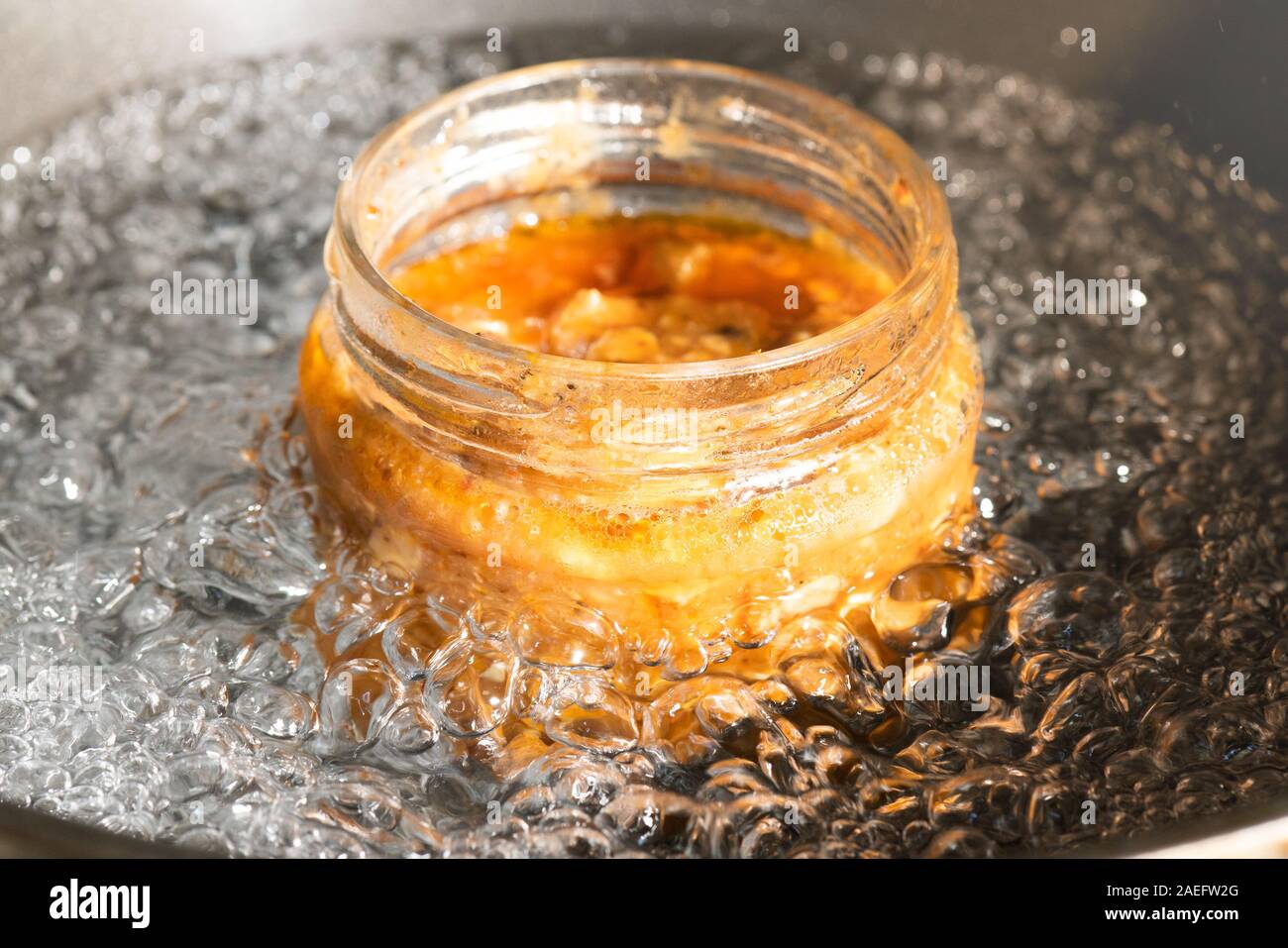 Bain-marie cooking with a food jar in middle of boiling water bath to ...