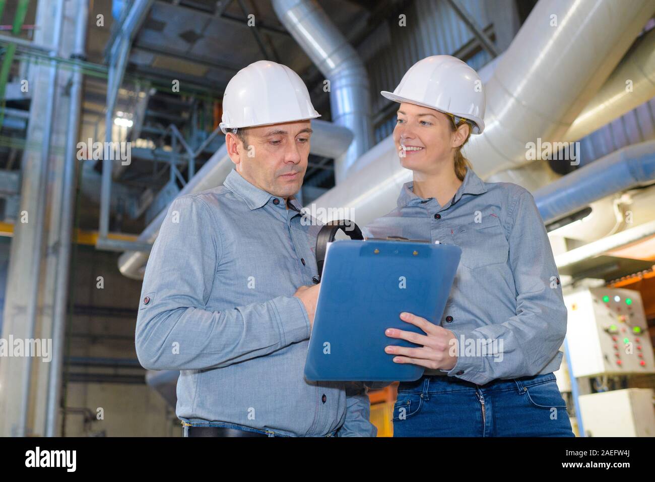 female and male engineer checking pipeline connections Stock Photo - Alamy