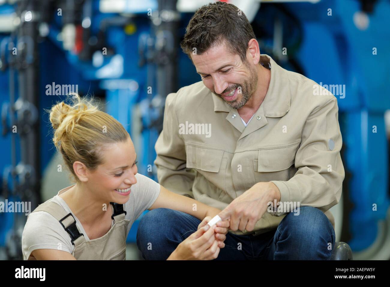 woman helping an injured man Stock Photo - Alamy