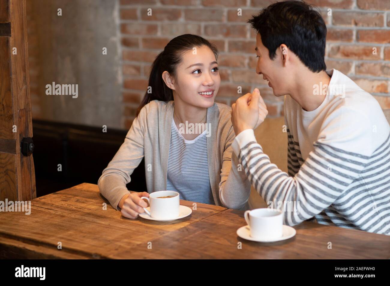 Loving couple in cafe holding hi-res stock photography and images - Alamy