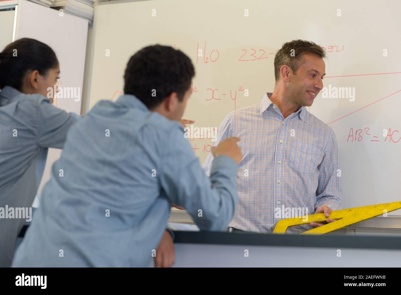 teacher with students and white board Stock Photo - Alamy