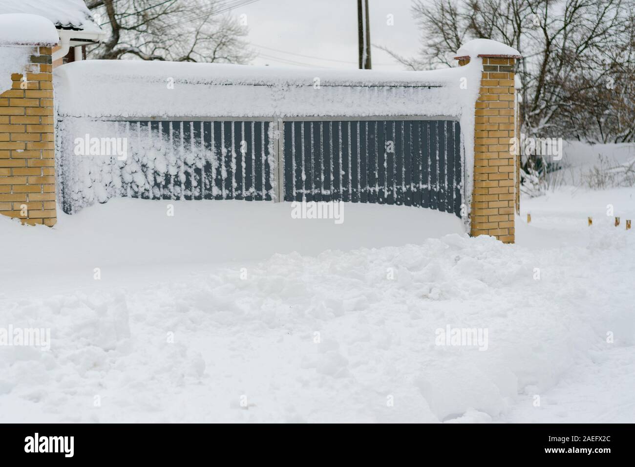 The entrance is covered with snow. Gates littered with snow Stock Photo ...