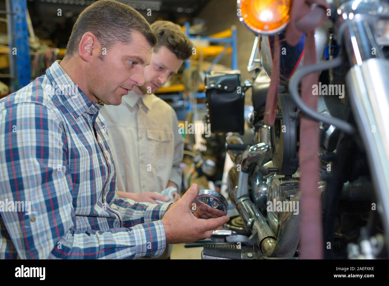 teacher with student in mechanics working Stock Photo - Alamy