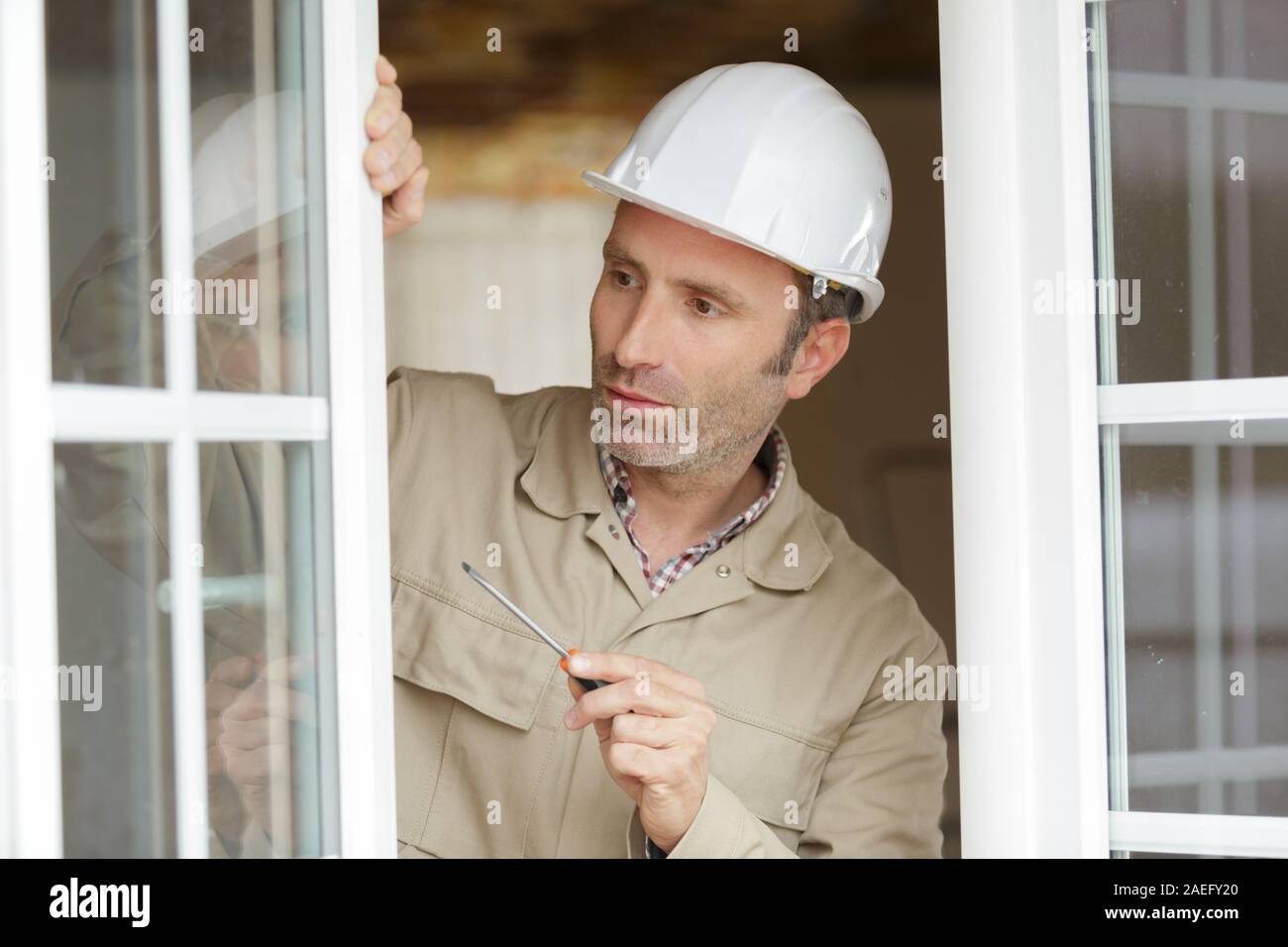 professional electrician man is fixing the window Stock Photo - Alamy