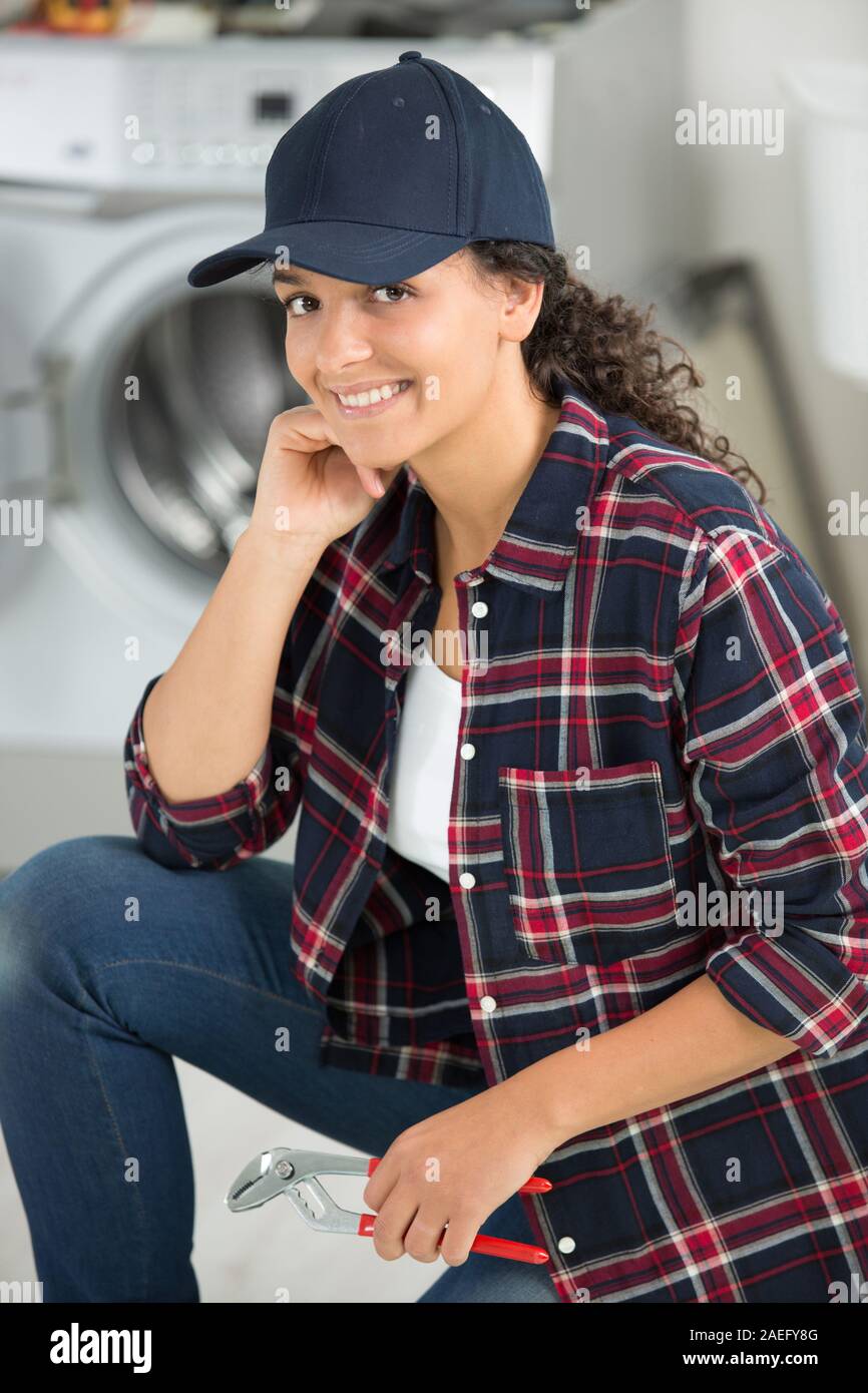 female plumber smiles at camera Stock Photo - Alamy