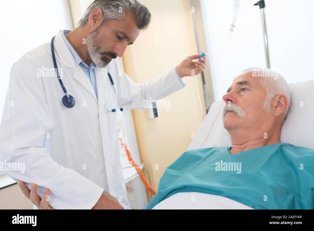 doctor assisting a senior patient Stock Photo - Alamy