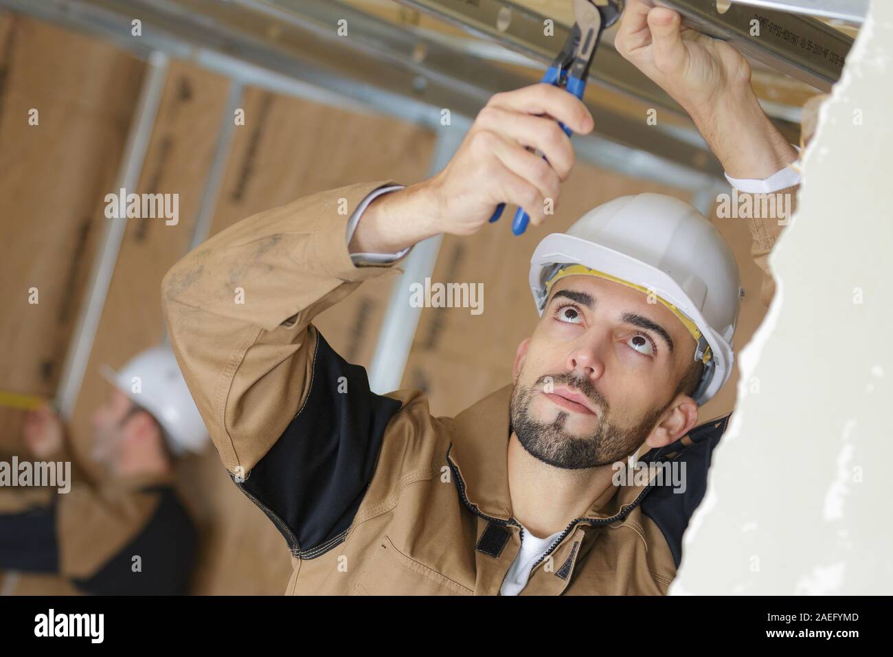builder fixing light bulb wiring in new house Stock Photo - Alamy