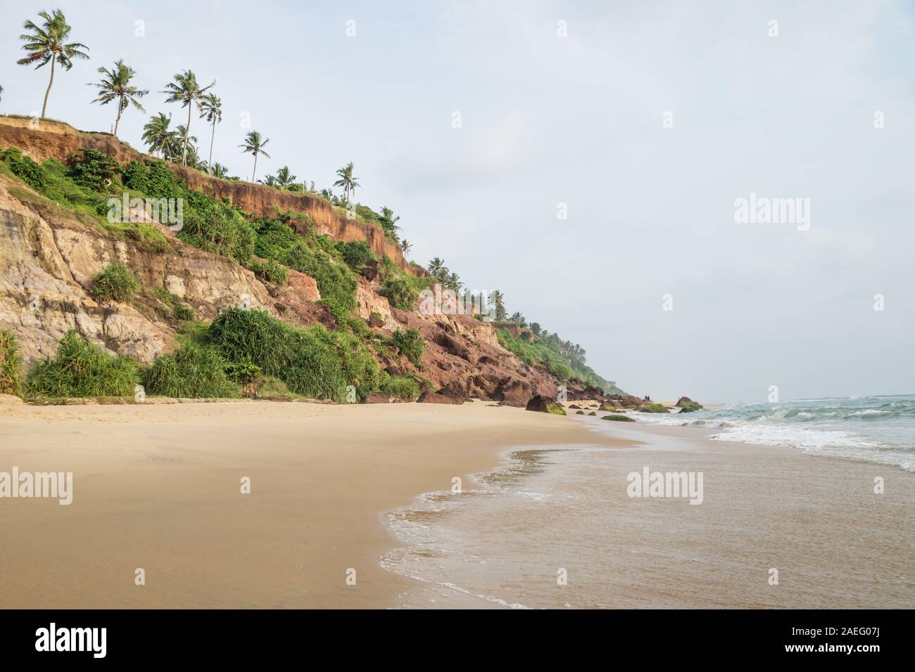 Water at cliff of Varkala along the coast with volcanic stones and ...