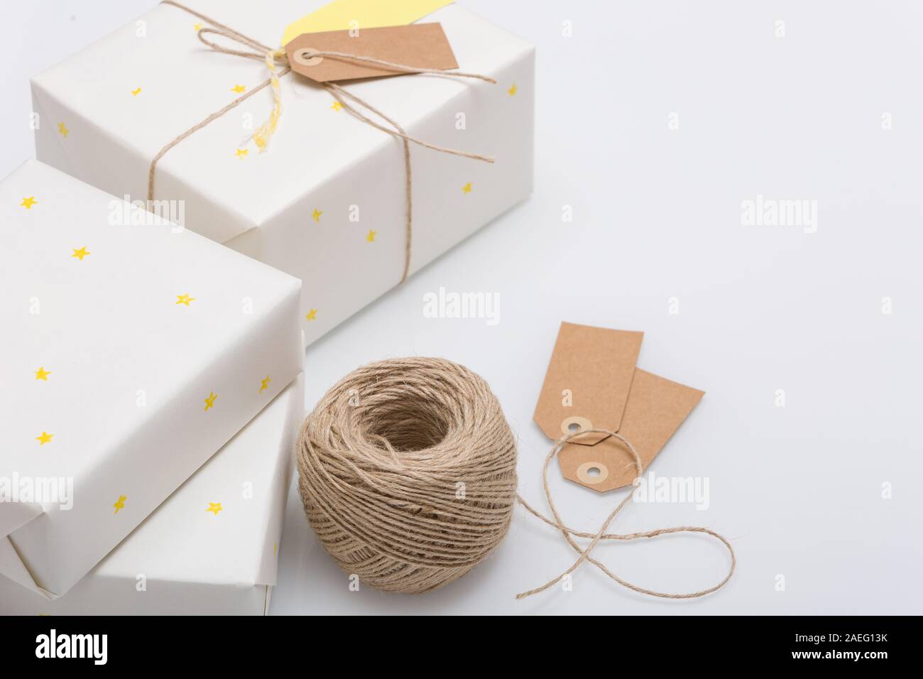 Nice present packed in white paper with small yellow stars on white ...