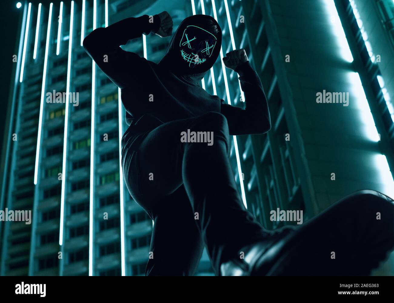 Portrait of an anonymous man in a black hoodie hiding his face behind a ...