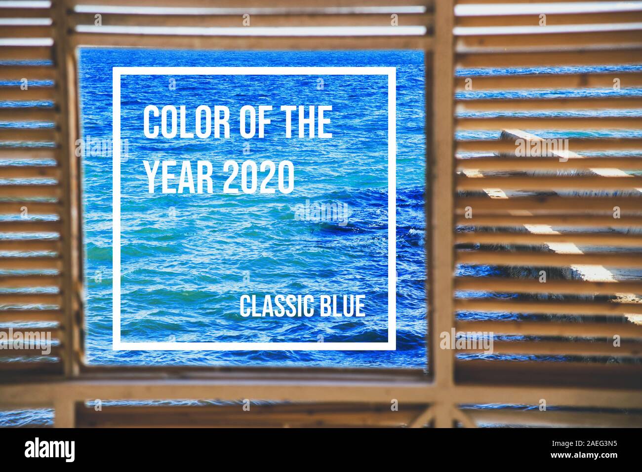 A square window overlooking classic blue colores sea from a wooden ...