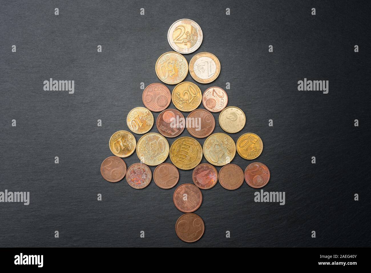 Christmas tree made out of Euro coins on dark black slate plate ...