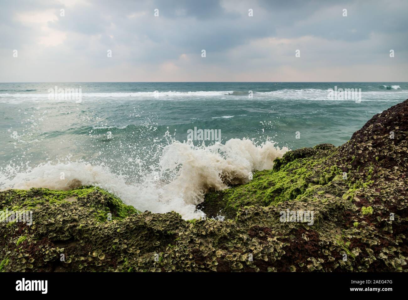 Splash of wave along coastside on volcanic stones of Varkala with dark ...