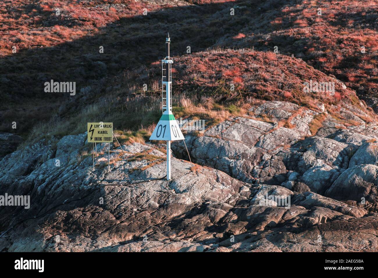 Standard white metal beacon and warning sign, navigational marks of ...