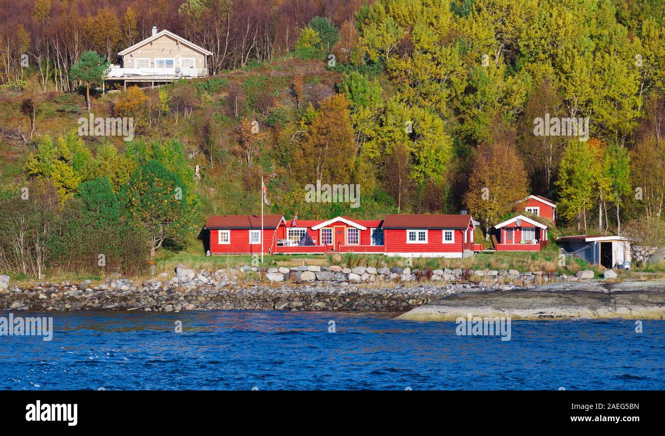 Traditional Norwegian coastal landscape, red wooden houses and barns on ...