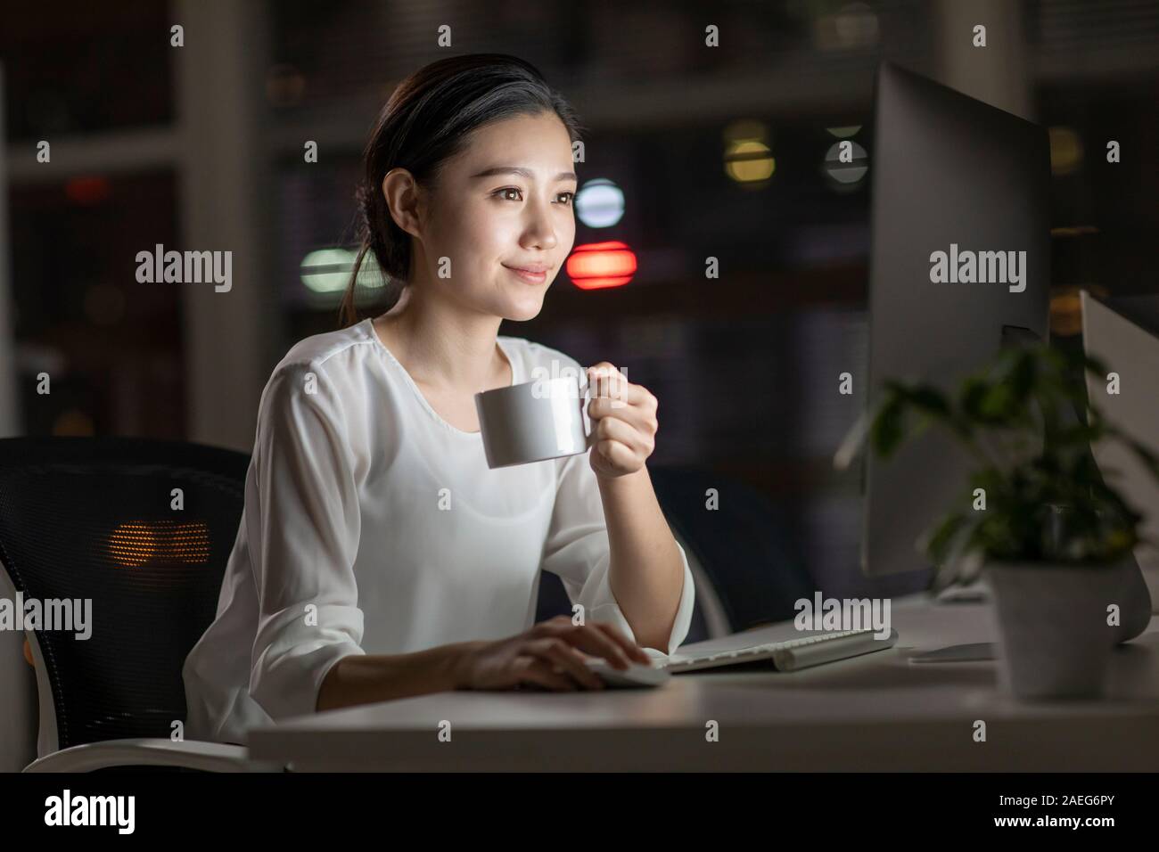 Young asian woman working late hi-res stock photography and images - Alamy
