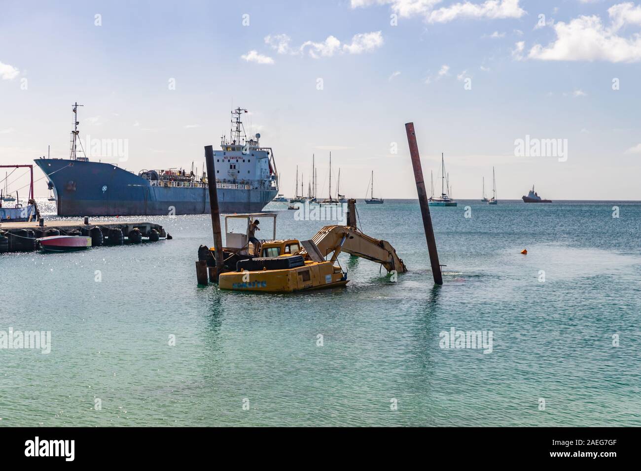 Dredging, pontoon excavator sunk in harbor in Carriacou, Grenada Stock ...