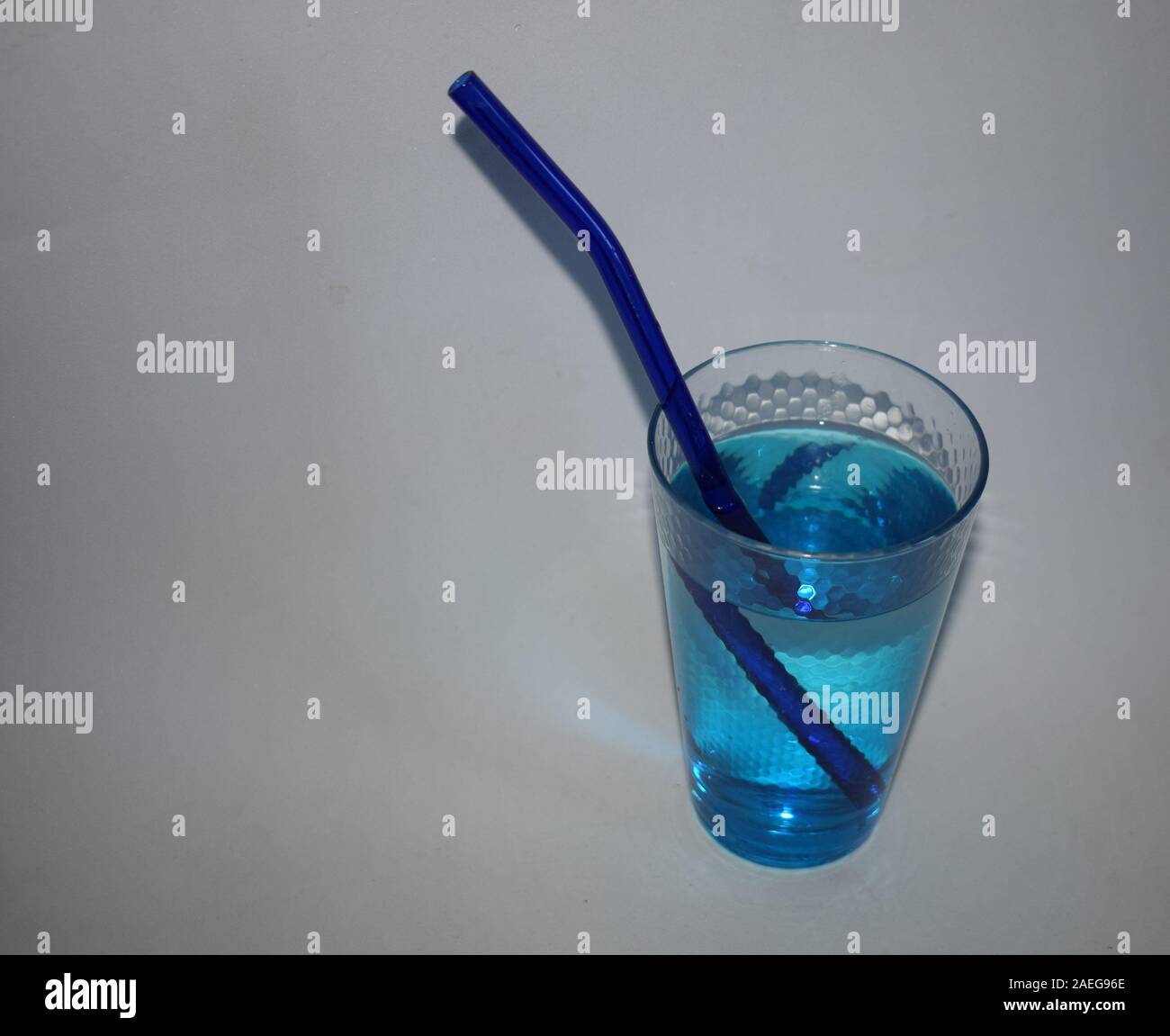 Blue glass cup with blue drinking straw with water, zero waste, on ...