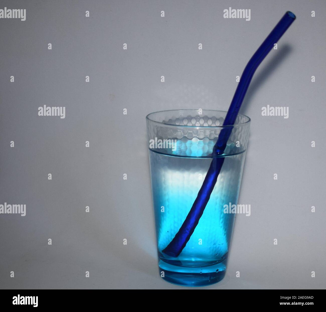 Blue and transparent glass cup with blue drinking straw, zero waste, on ...