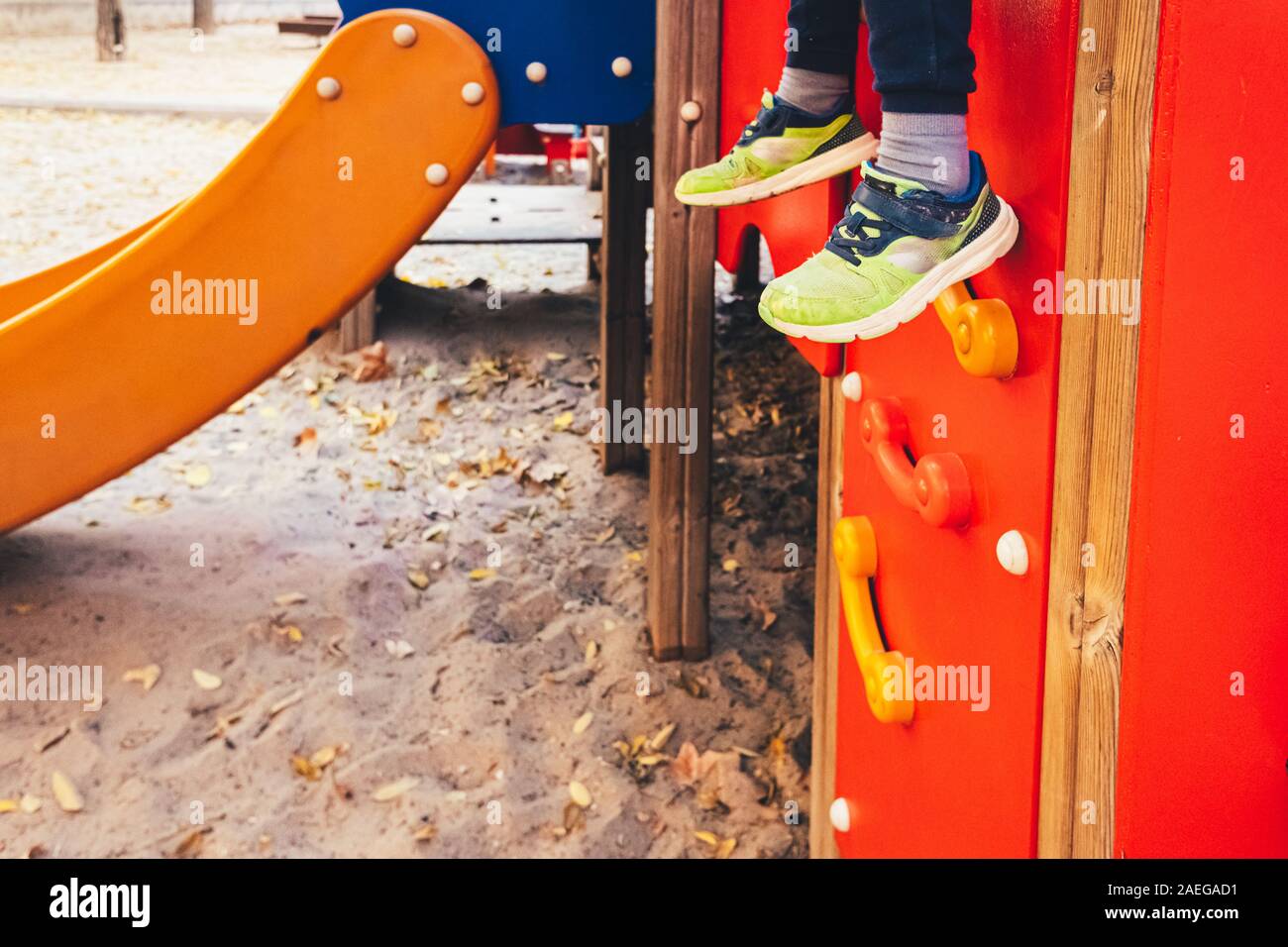 Feet hanging as a child playing in a playground Stock Photo - Alamy