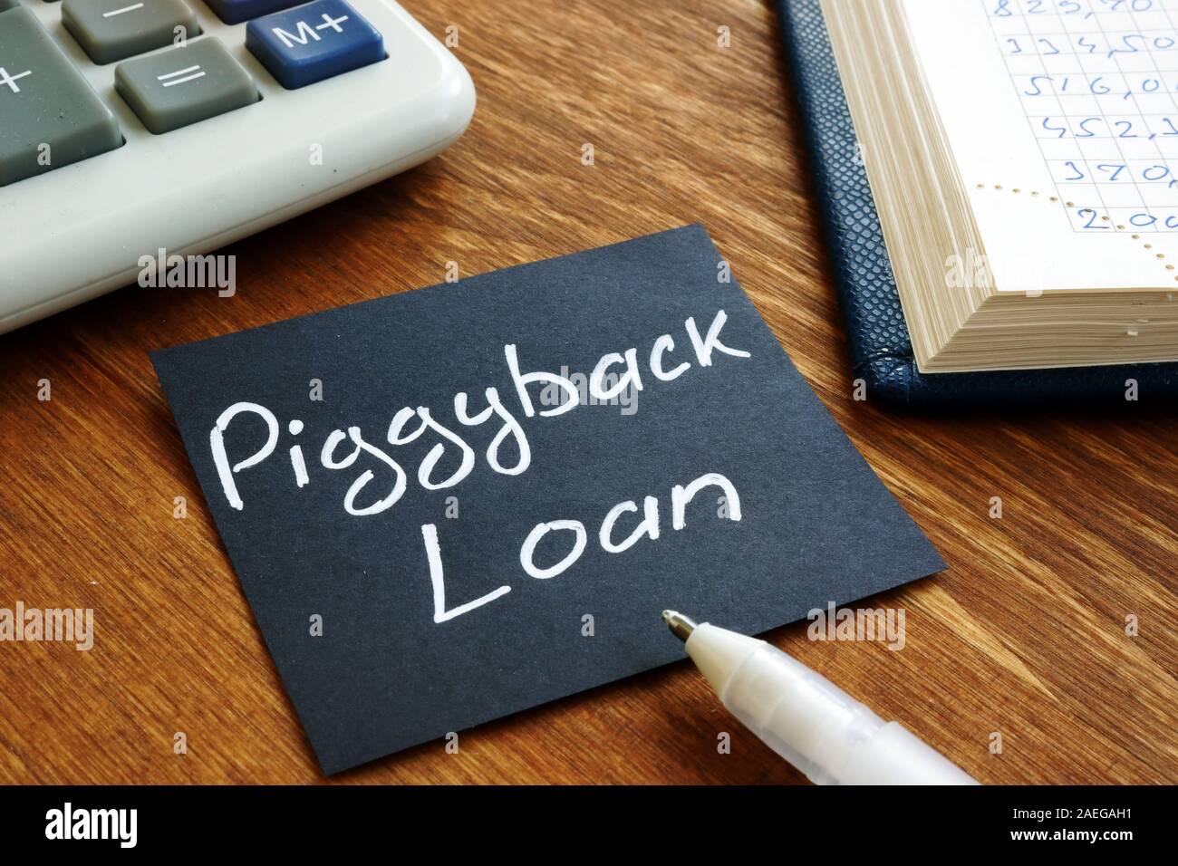 Piggyback loan handwritten sign on the black sheet Stock Photo - Alamy