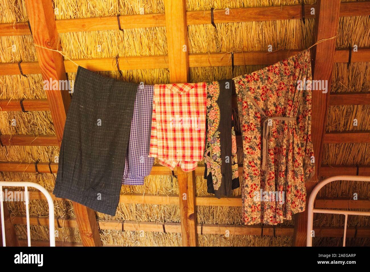 Vintage clothes hanging on a wire with clothespins in a wooden house ...