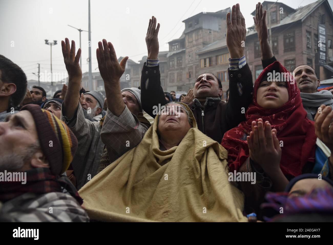 Kashmiri Muslims raise their hands while beseeching for blessings as ...