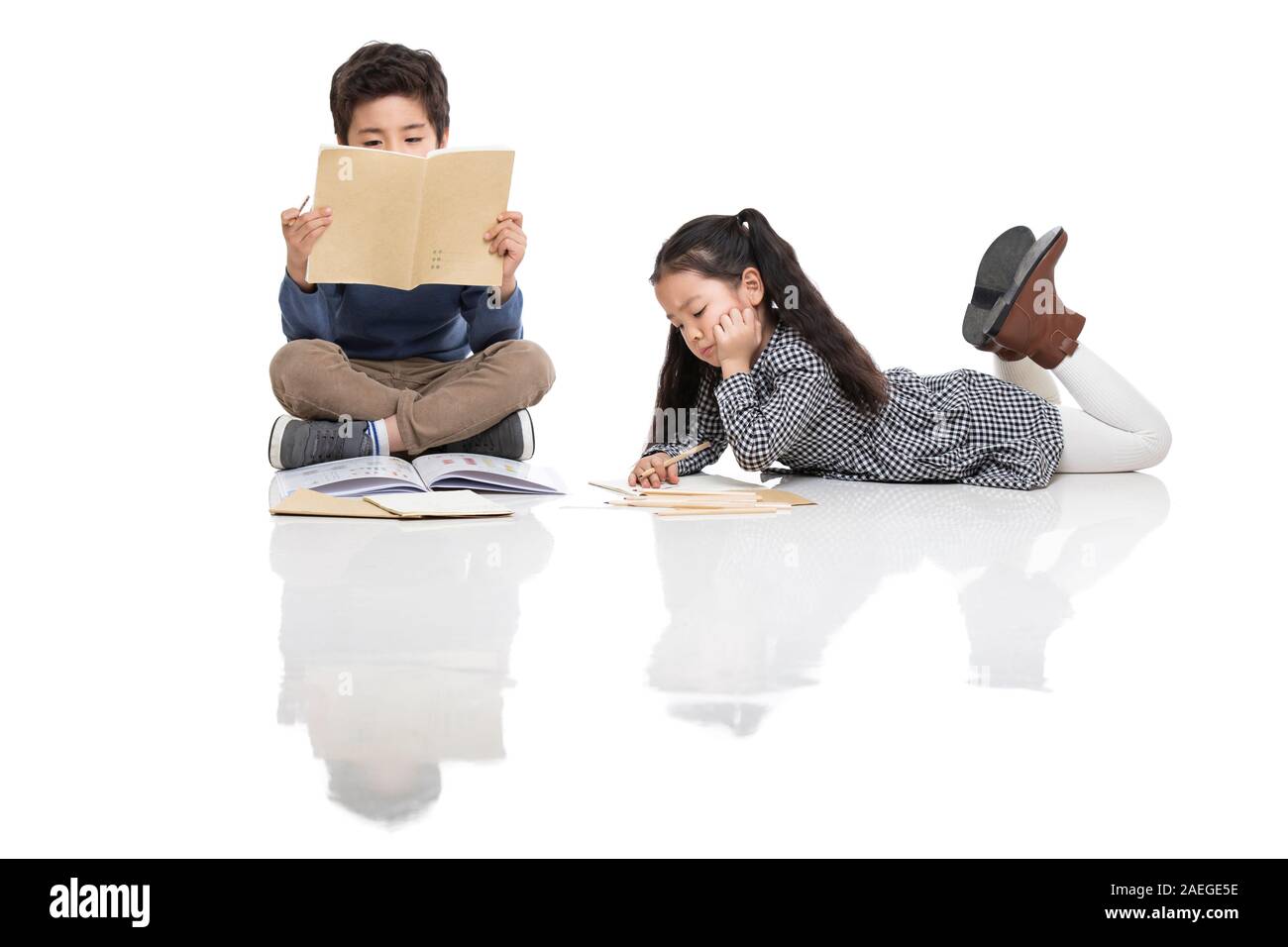 Two children studying together Stock Photo - Alamy