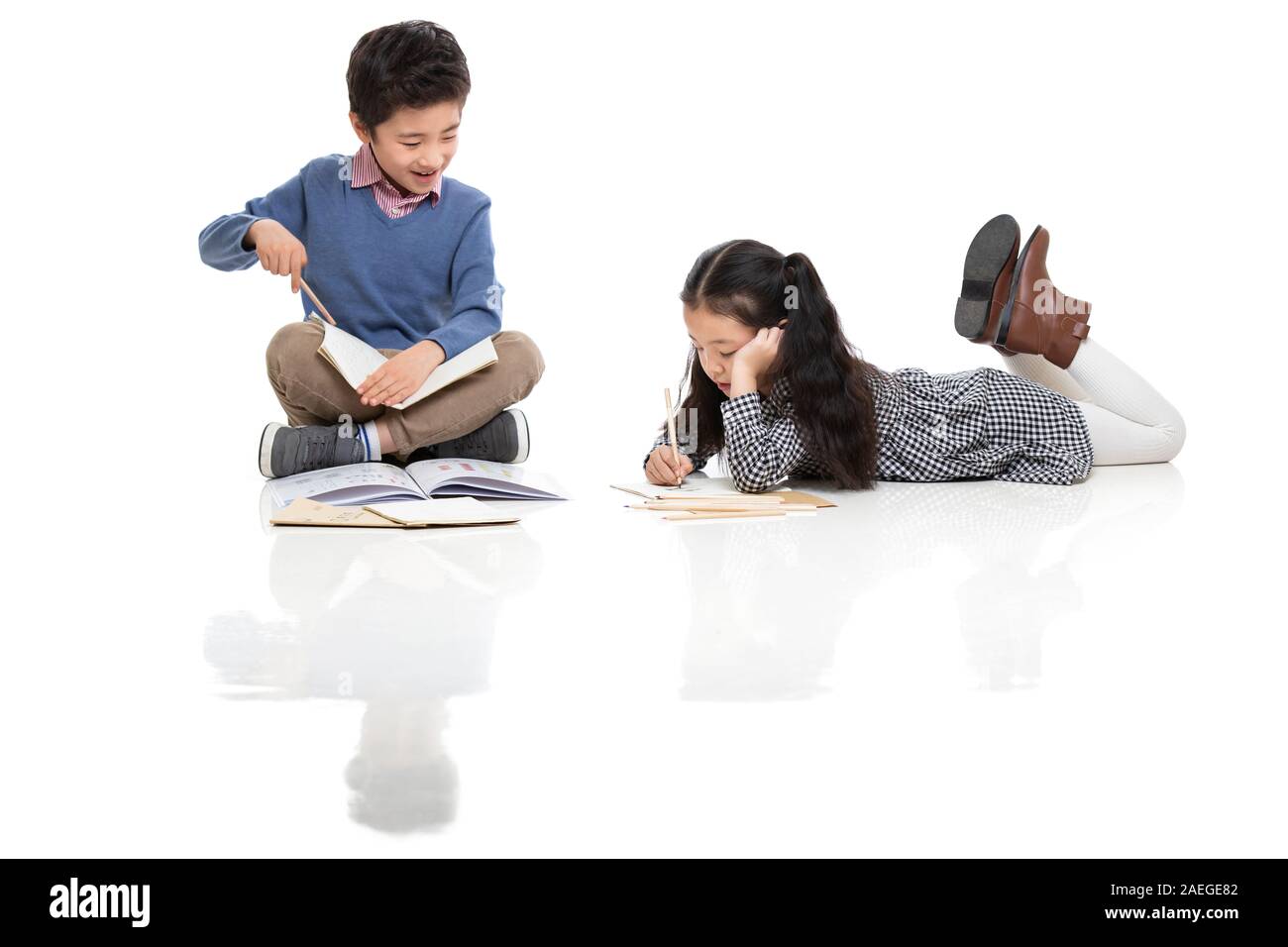 Two children studying together Stock Photo - Alamy