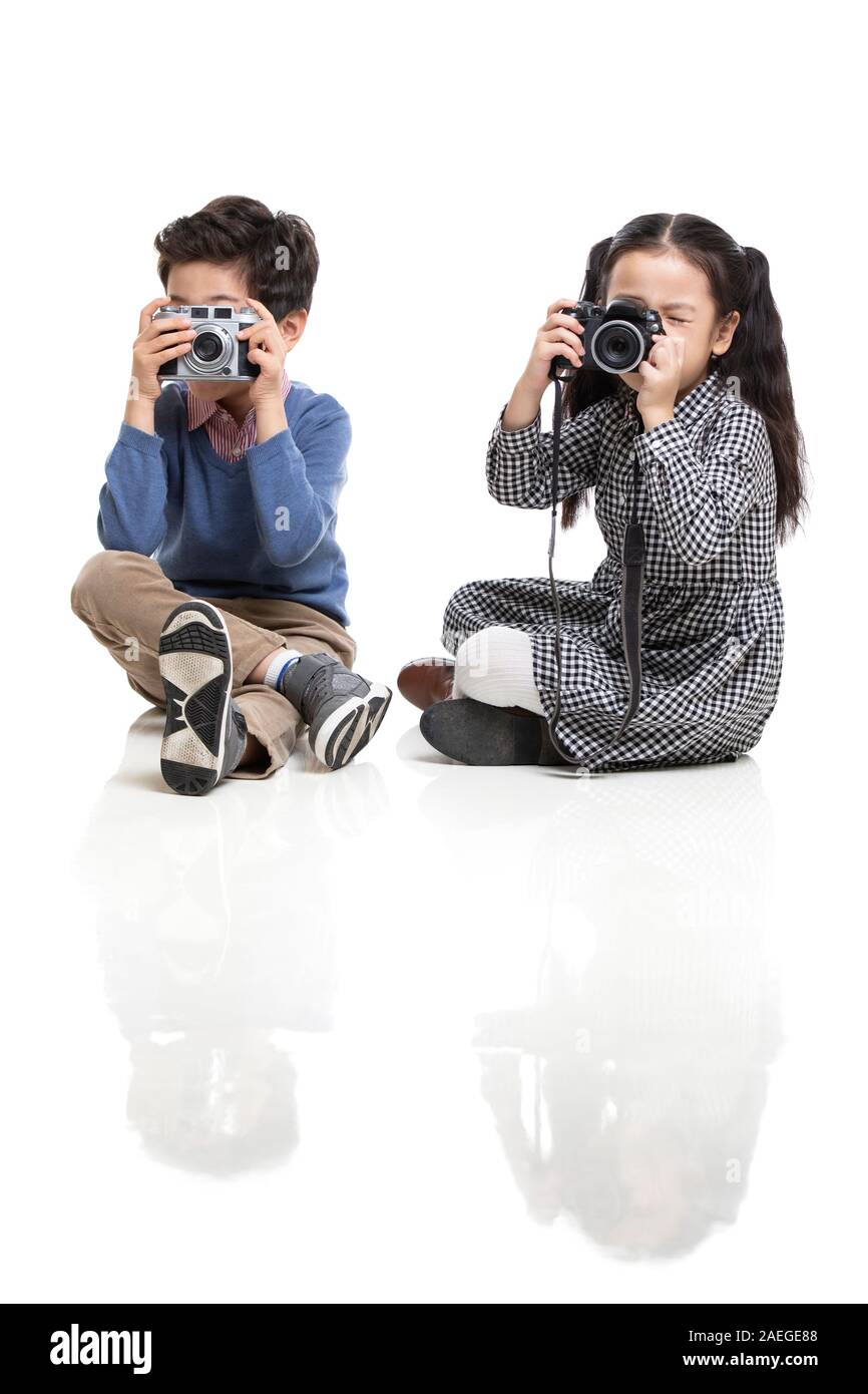 Two children taking photos Stock Photo - Alamy