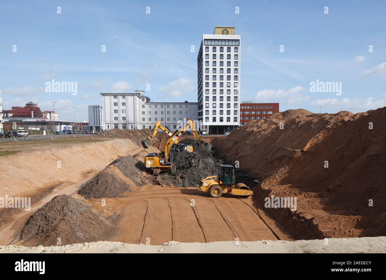 Excavator with excavator shovel scoops sand on a construction site ...