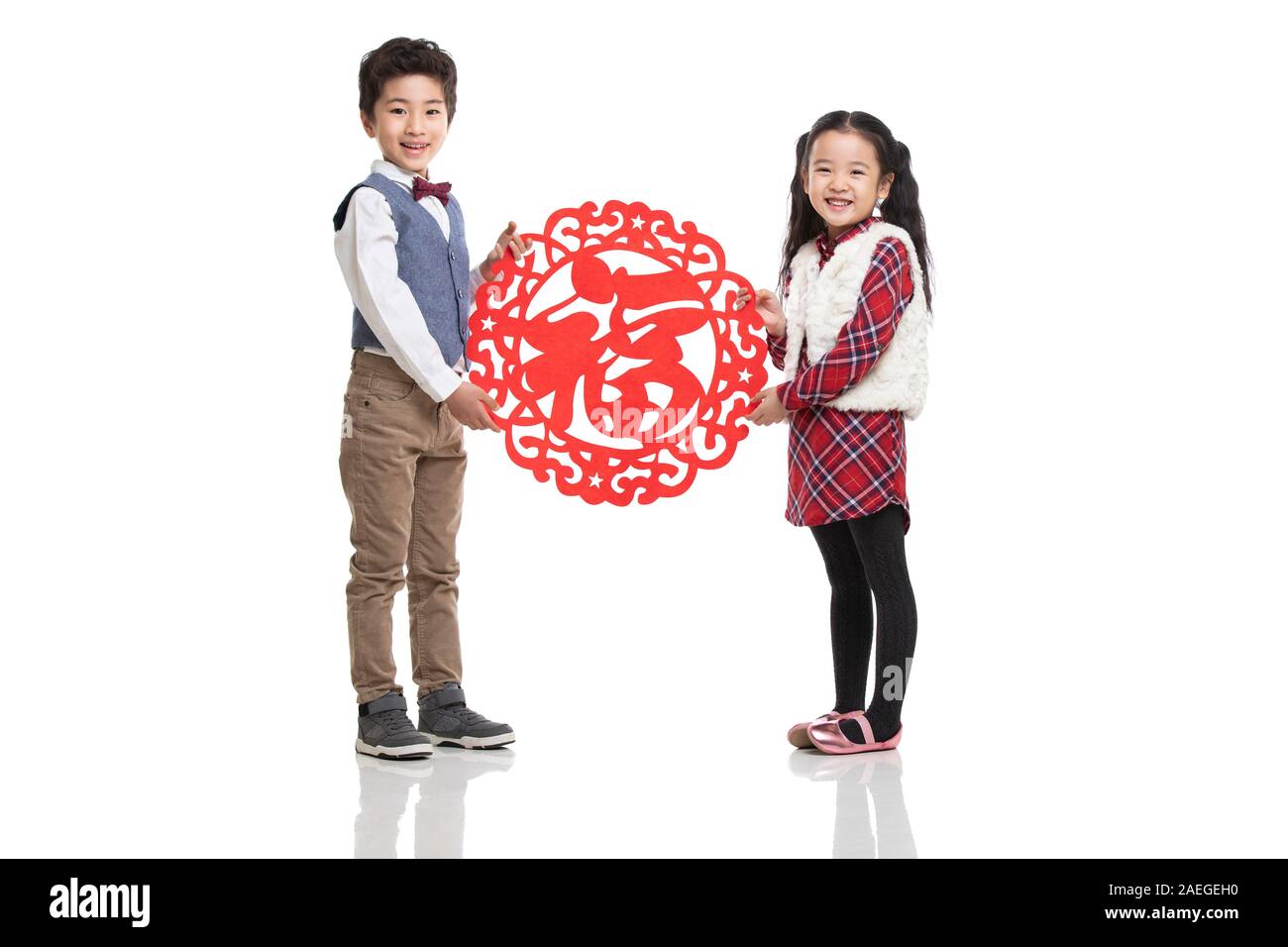 Happy sibling celebrating Chinese New Year Stock Photo - Alamy